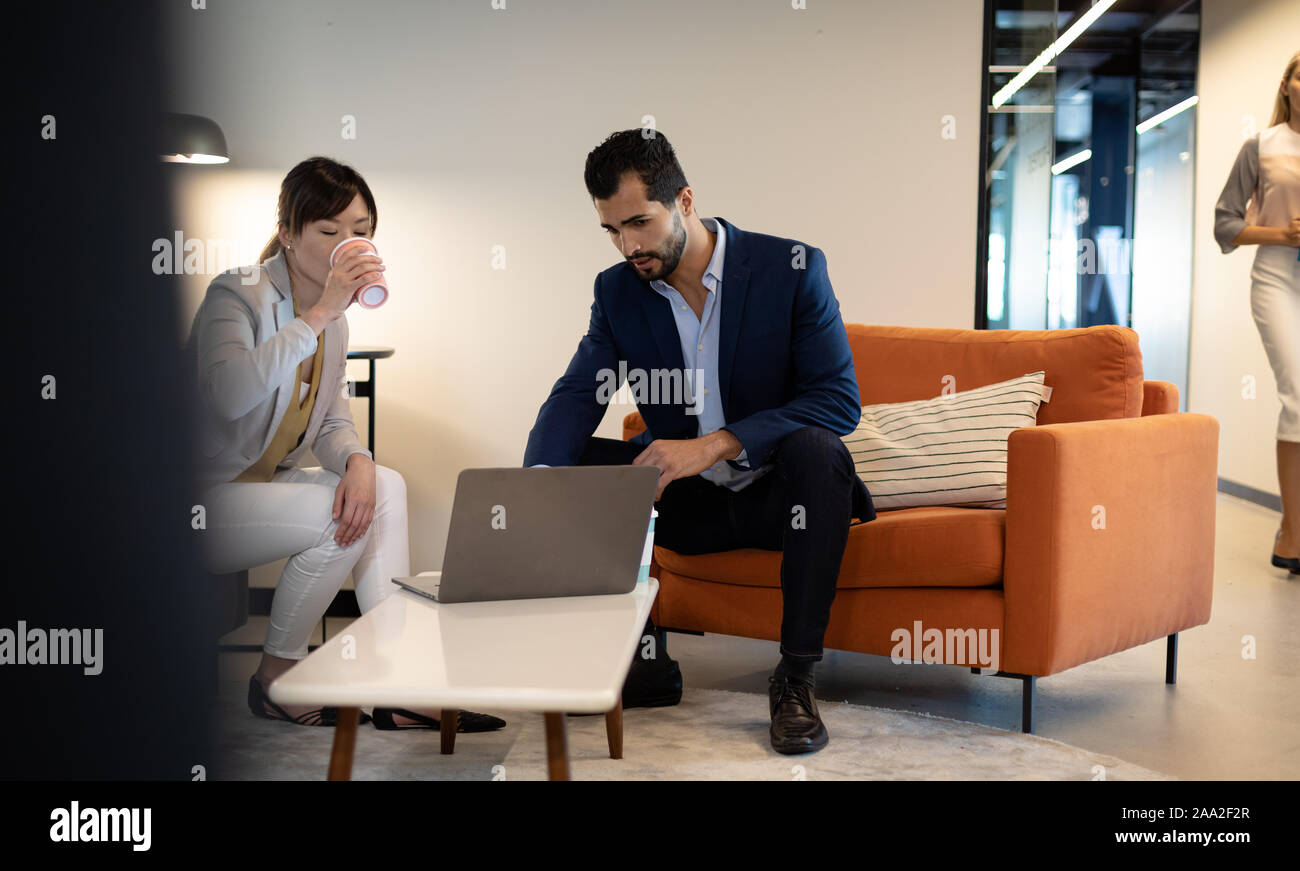 Young male female professionals hi-res stock photography and images - Alamy