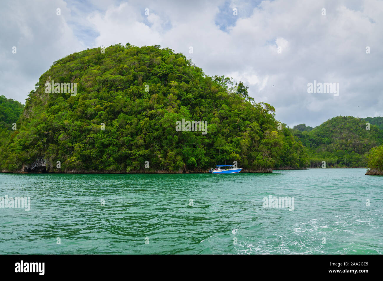 Boat anchored close to exotic tropical island. Panoramic landscape view ...