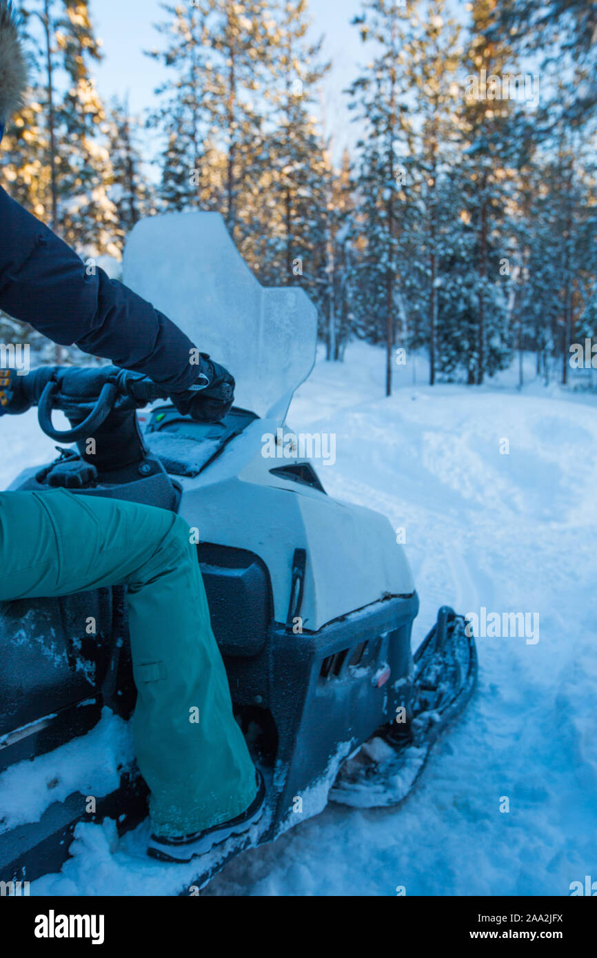 Rider on the snowmobile in winter snow in the morning side view ...