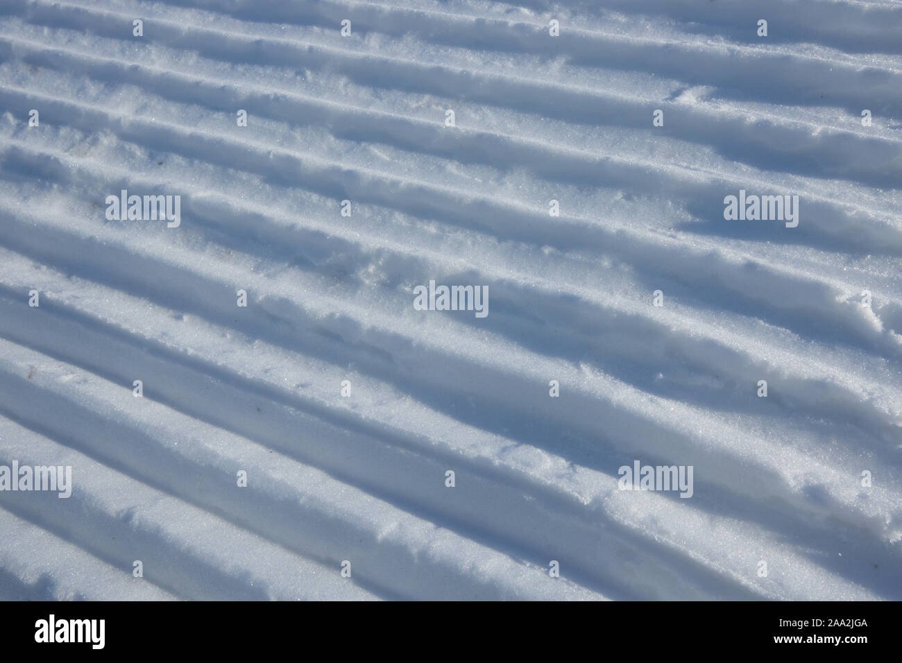 Snow lines made from a snow machine on a ski slope Stock Photo - Alamy