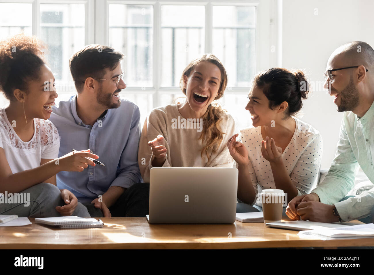 Positive diverse people having fun, watching funny videos together ...