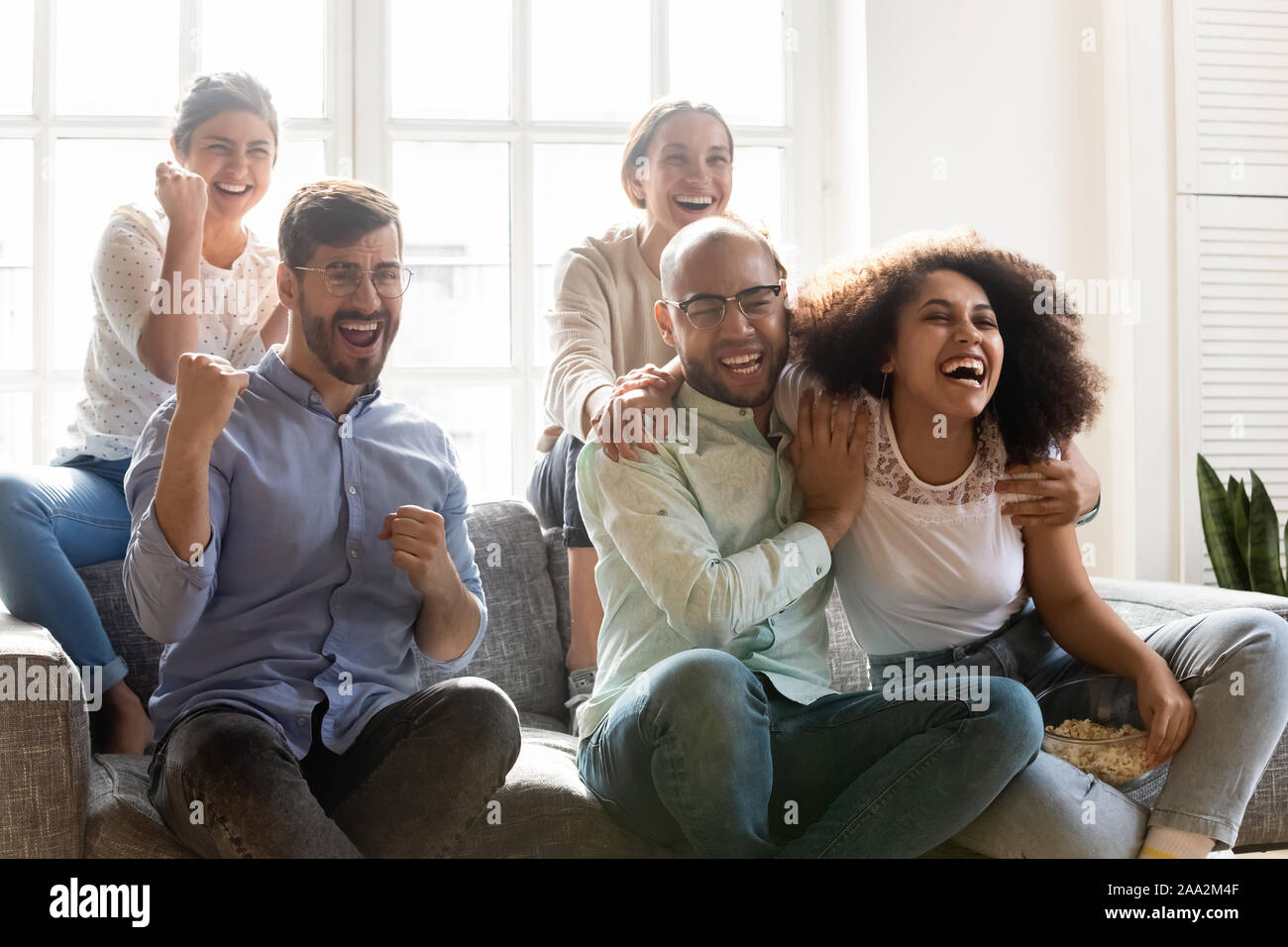 Overjoyed young mixed race people supporting favorite team Stock Photo ...