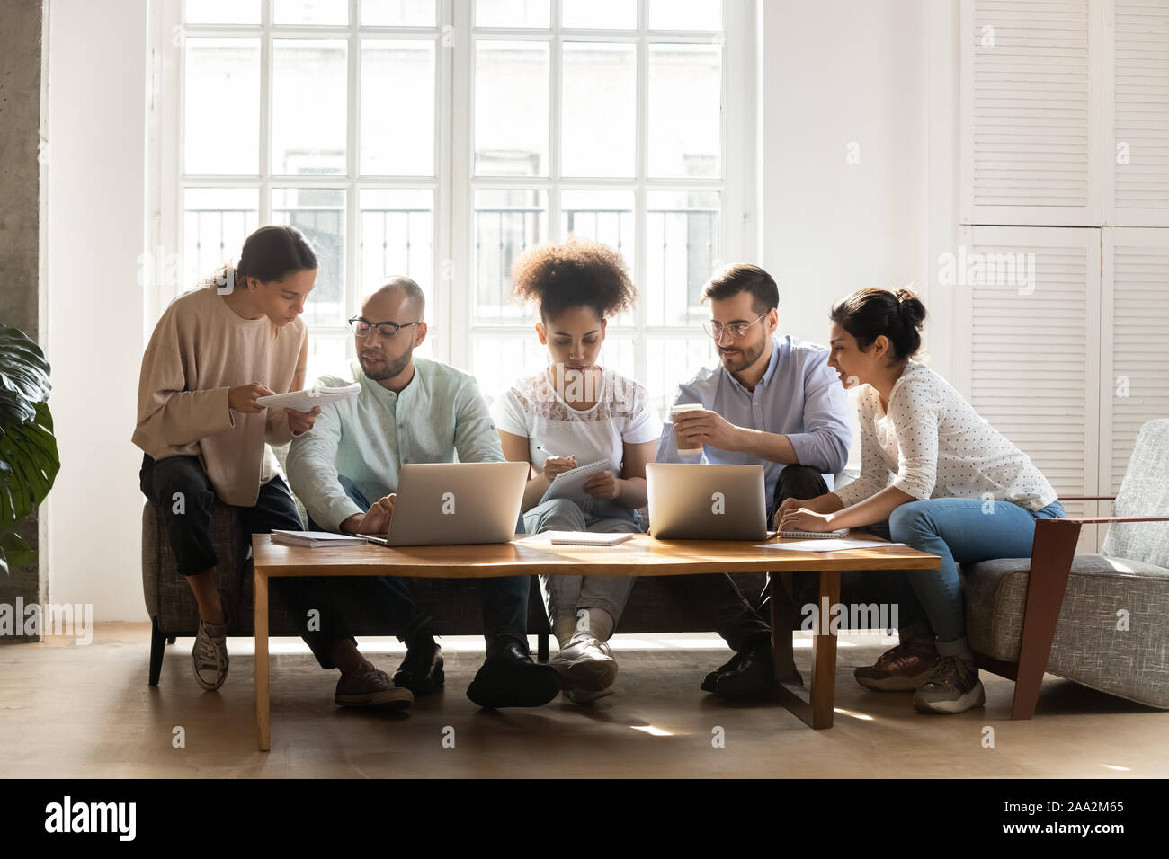 Focused multiracial people working together on project Stock Photo - Alamy