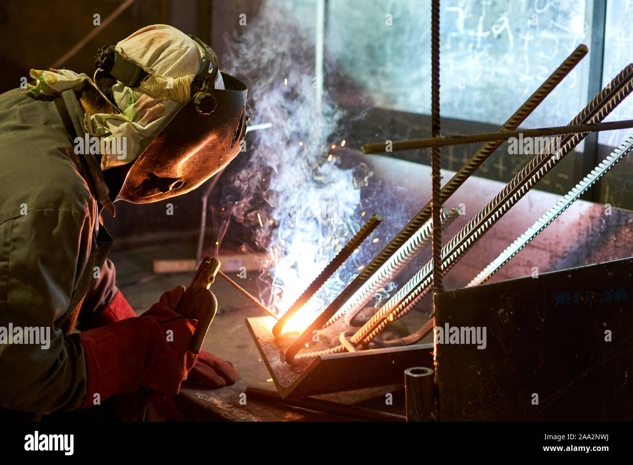 Welder working welding machine. Bright flashes and smoke.. Welding of ...