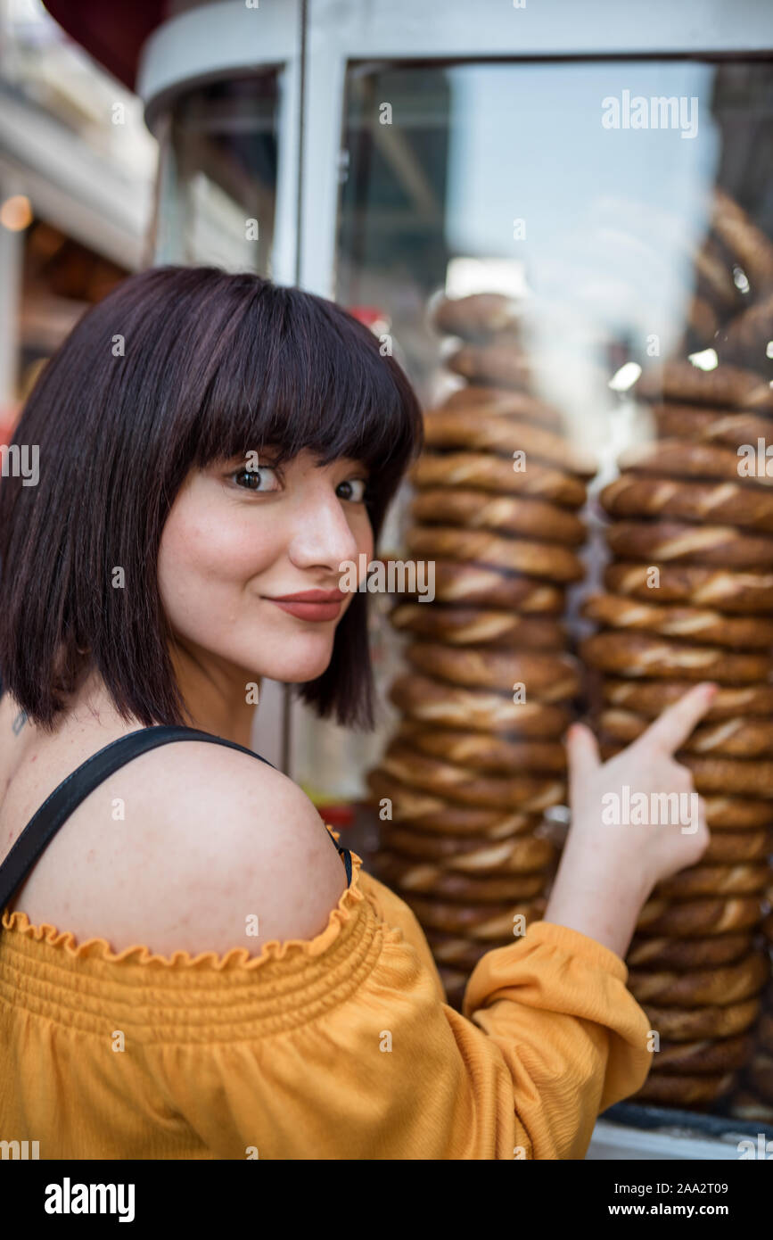 Beautiful young girl in fashionable clothes shows stall of traditional ...