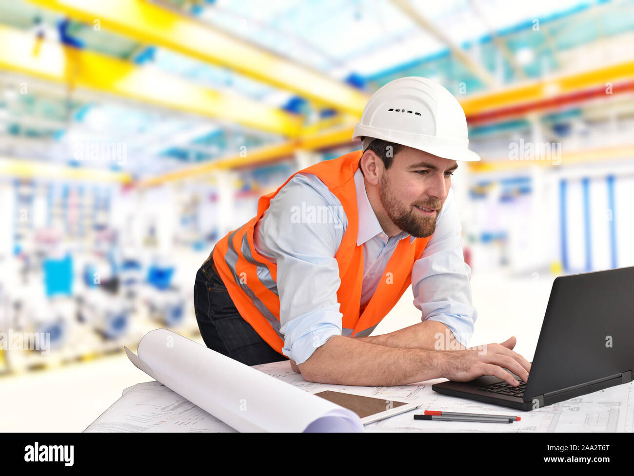 engineer at his workplace with notebook in an industrial company in ...