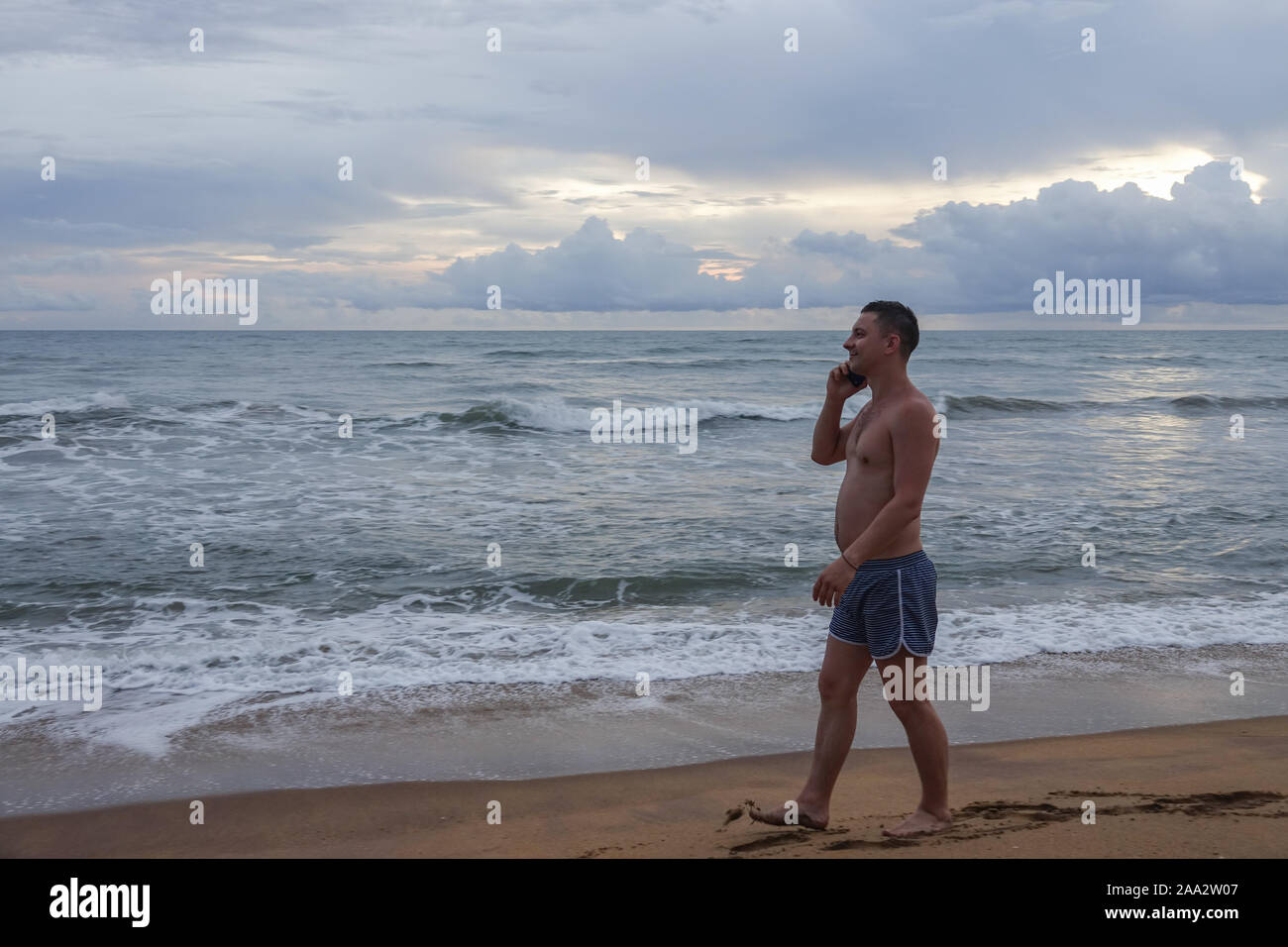 On mobile on beach hi-res stock photography and images - Alamy