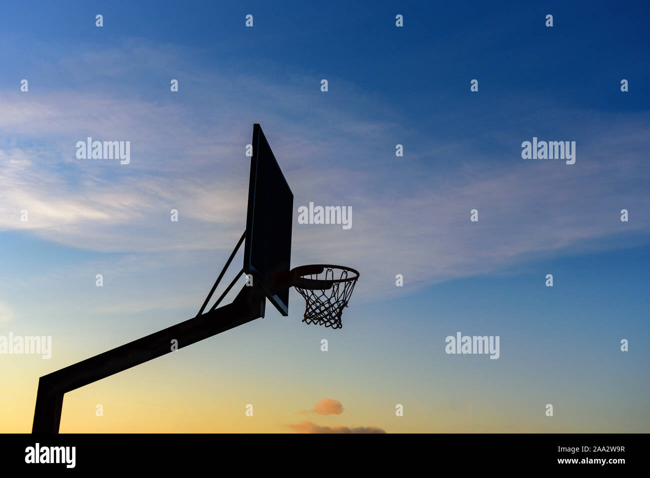 Street basketball hoop on sunset sky. Goal and win concept Stock Photo ...