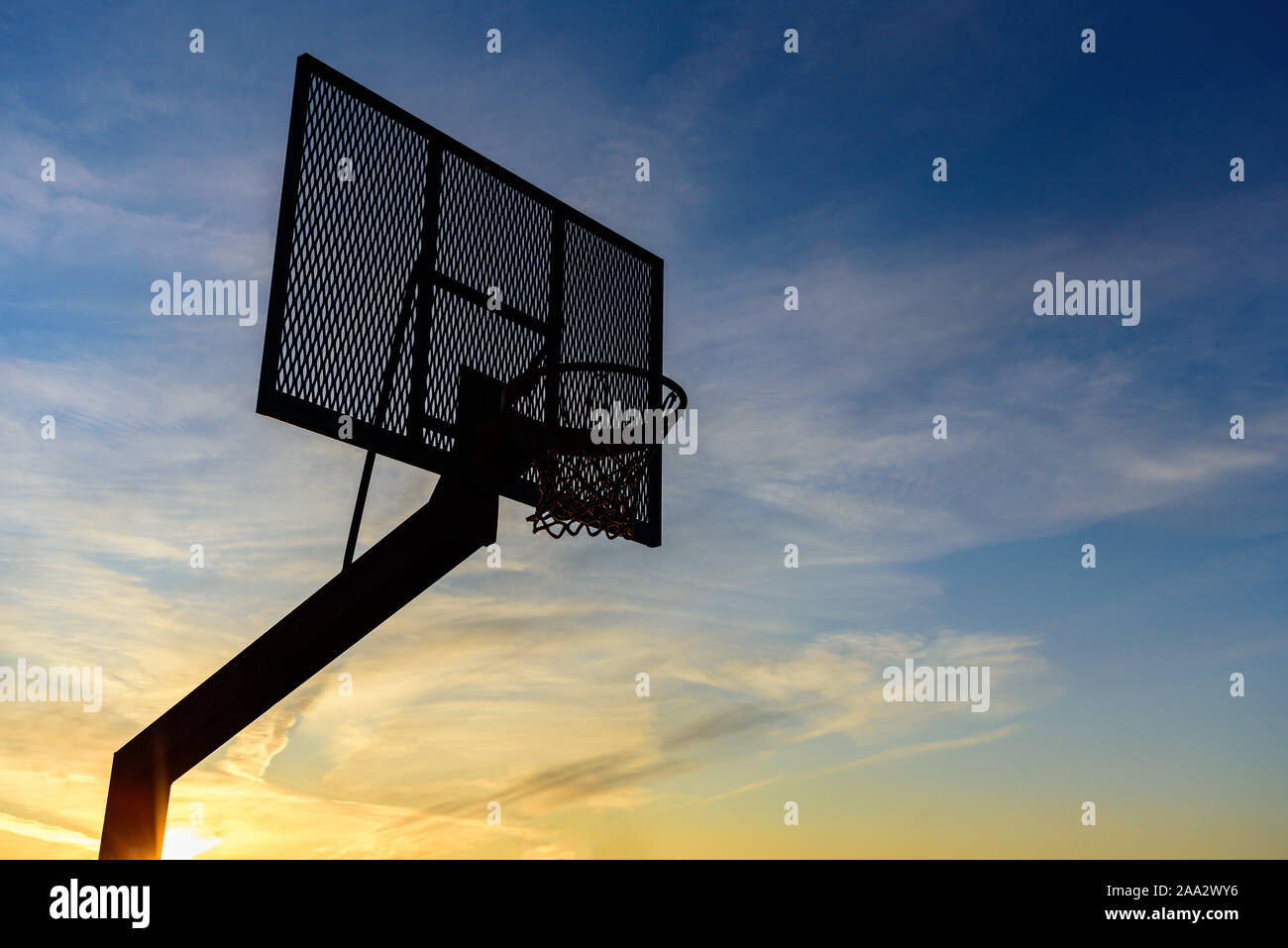 Street basketball hoop on sunset sky. Goal and win concept Stock Photo ...