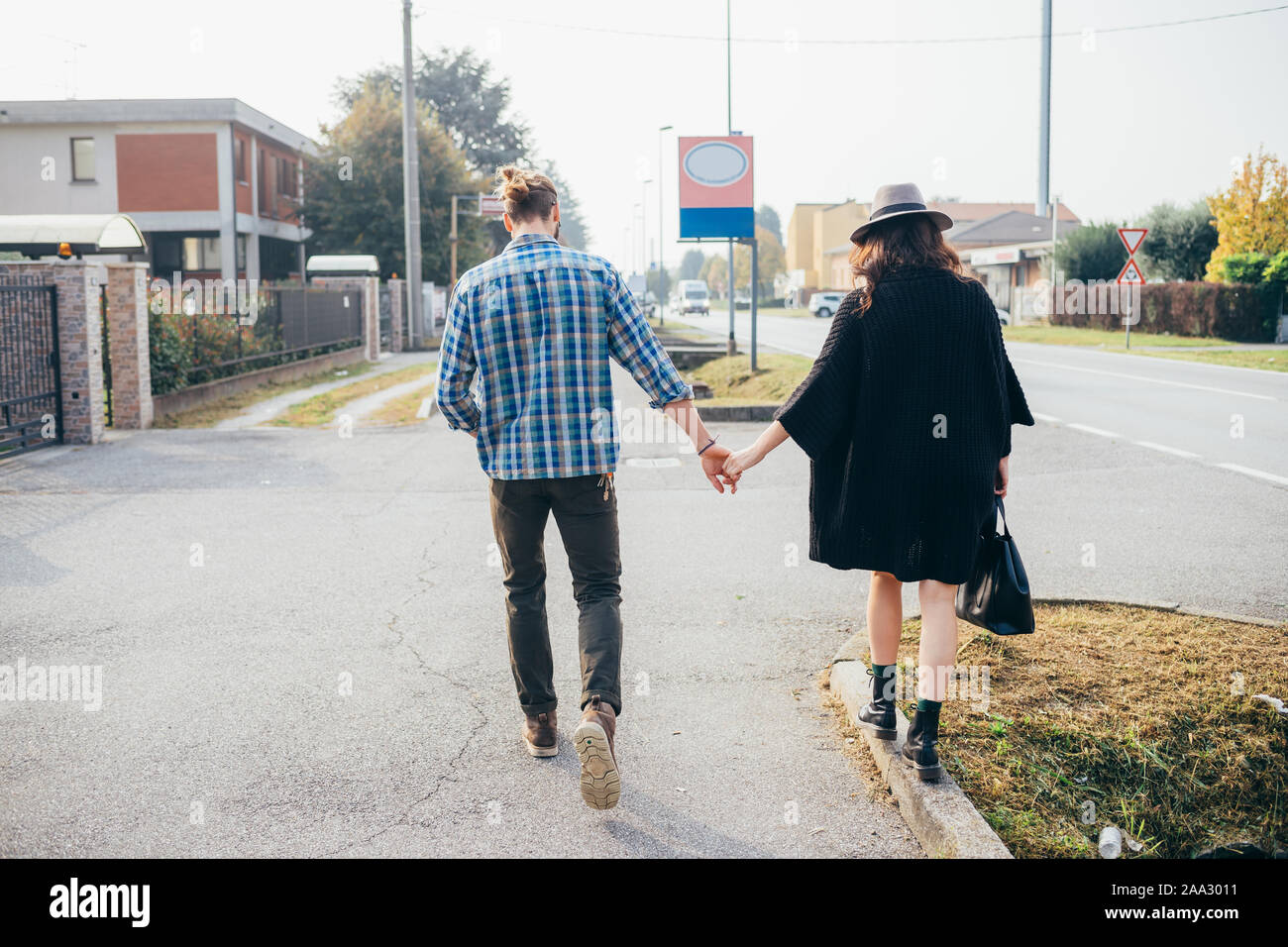 back view affectionate beautiful couple walking outdoor holding hands ...