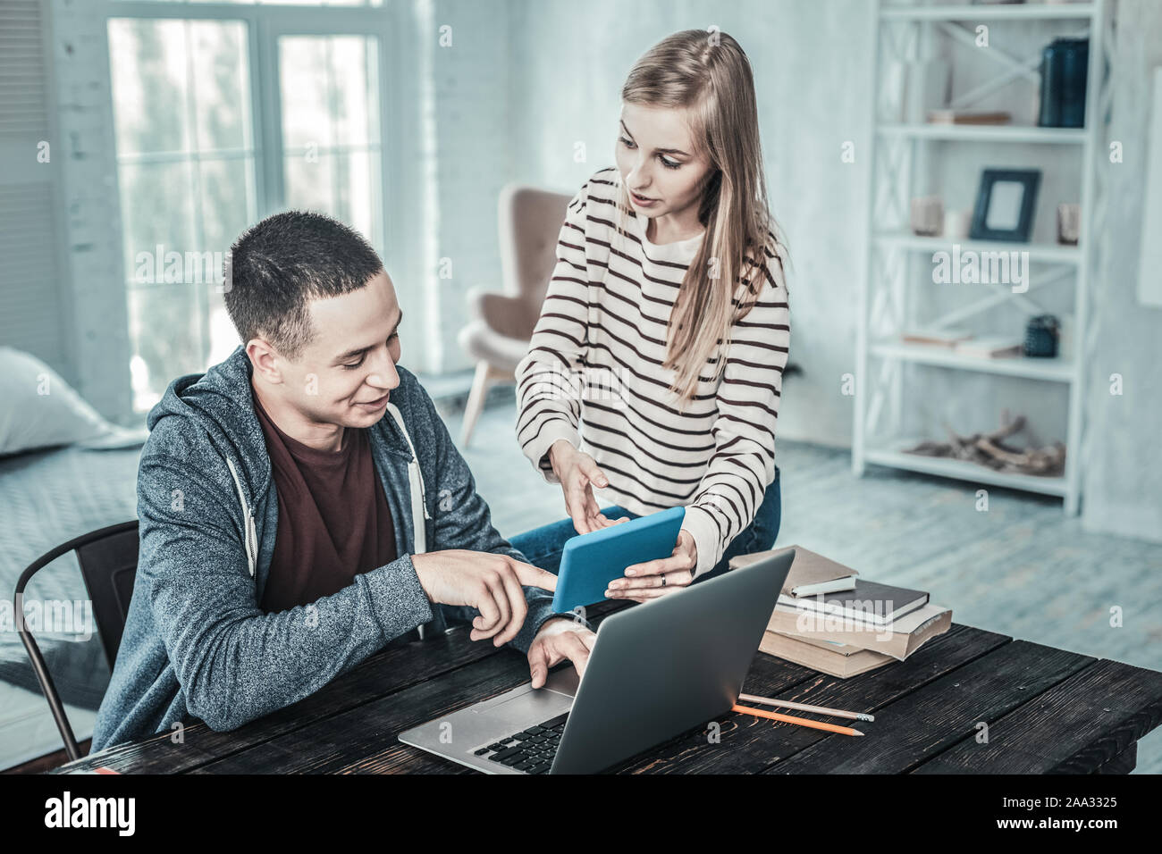 Beautiful blonde woman speaking to her colleague Stock Photo - Alamy