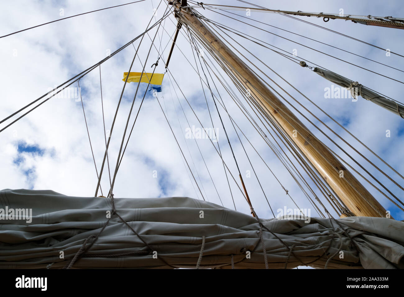 Mast, ropes and sails collected from an old sailboat seen from below ...