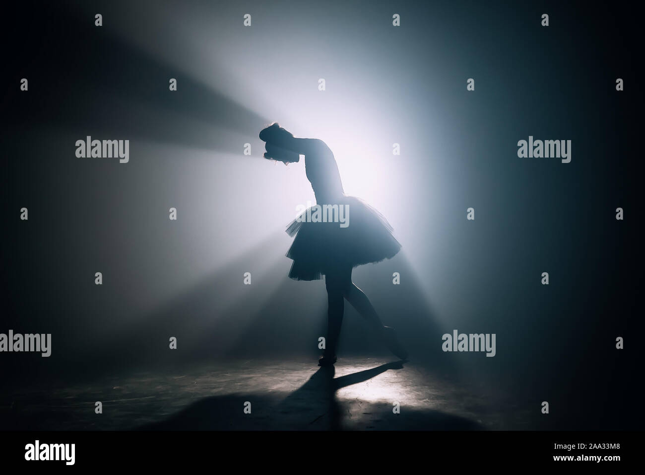 Silhouette of ballerina who has finished dancing her part in ...