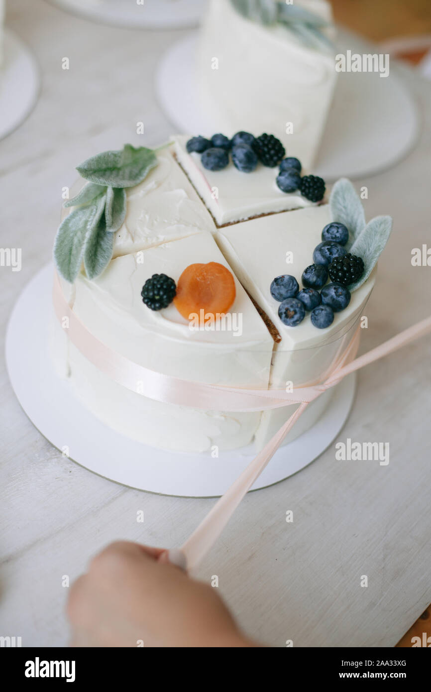Woman tying together four slices of cake to make a compound cake Stock ...