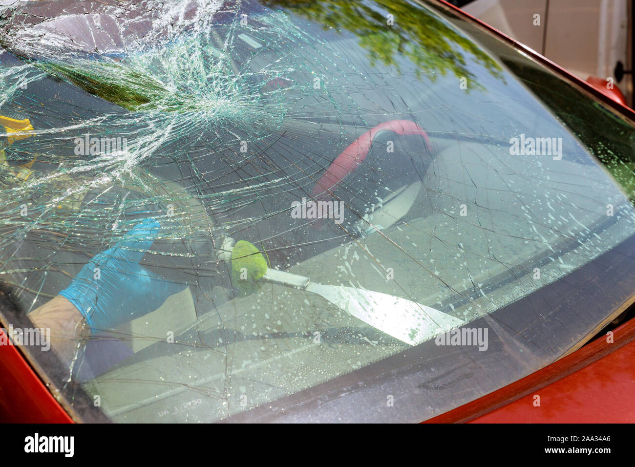 Serviceman removing windshield on a car crashed a car service Stock ...