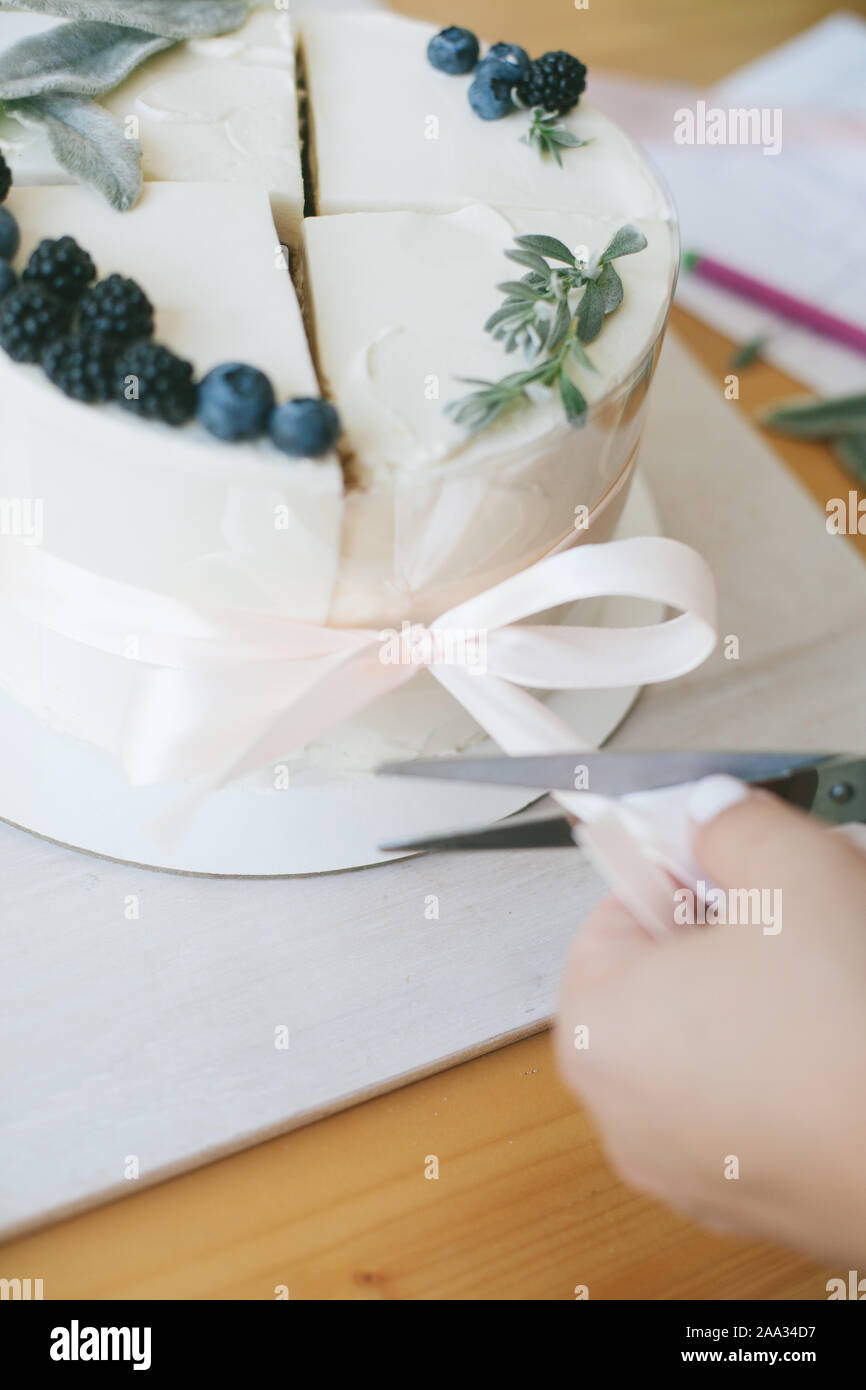 Woman tying together four slices of cake to make a compound cake Stock ...