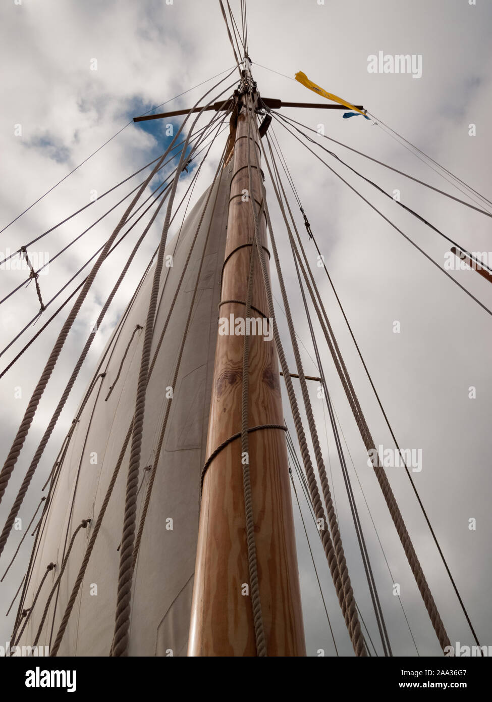 Mast, ropes and sails collected from an old sailboat seen from below ...
