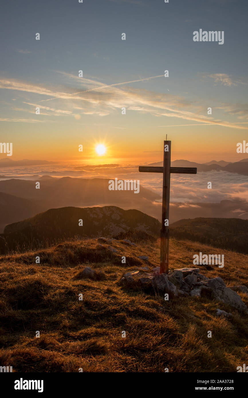 Sunlit cross on top of a mountain, Bohinj Stock Photo - Alamy