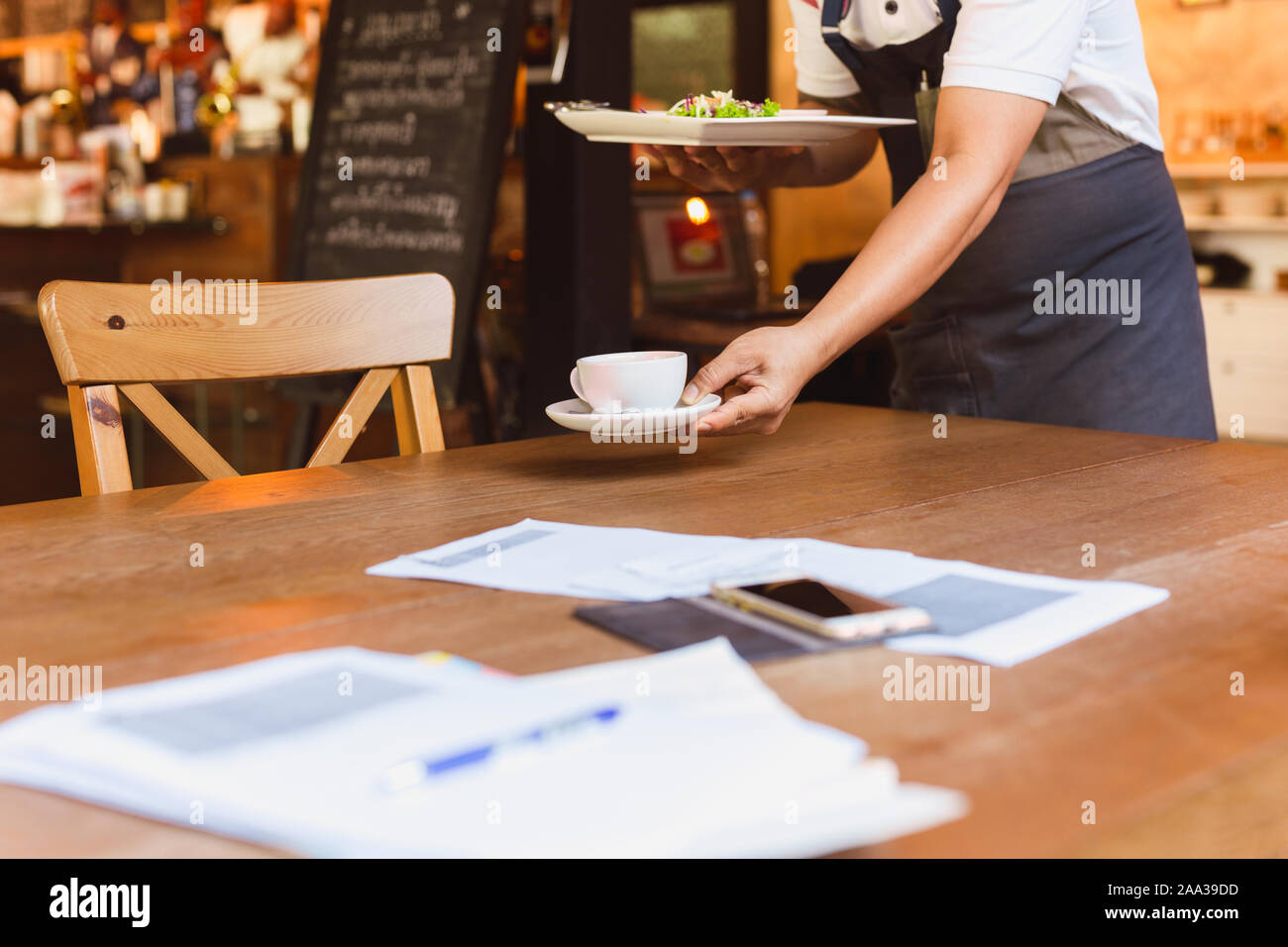 Person standing left of table hi-res stock photography and images - Alamy