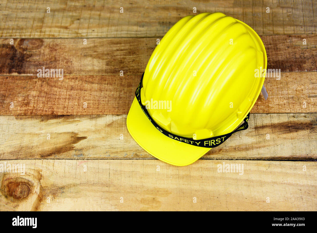 Engineer worker helmet on wooden background / Safety first concept ...