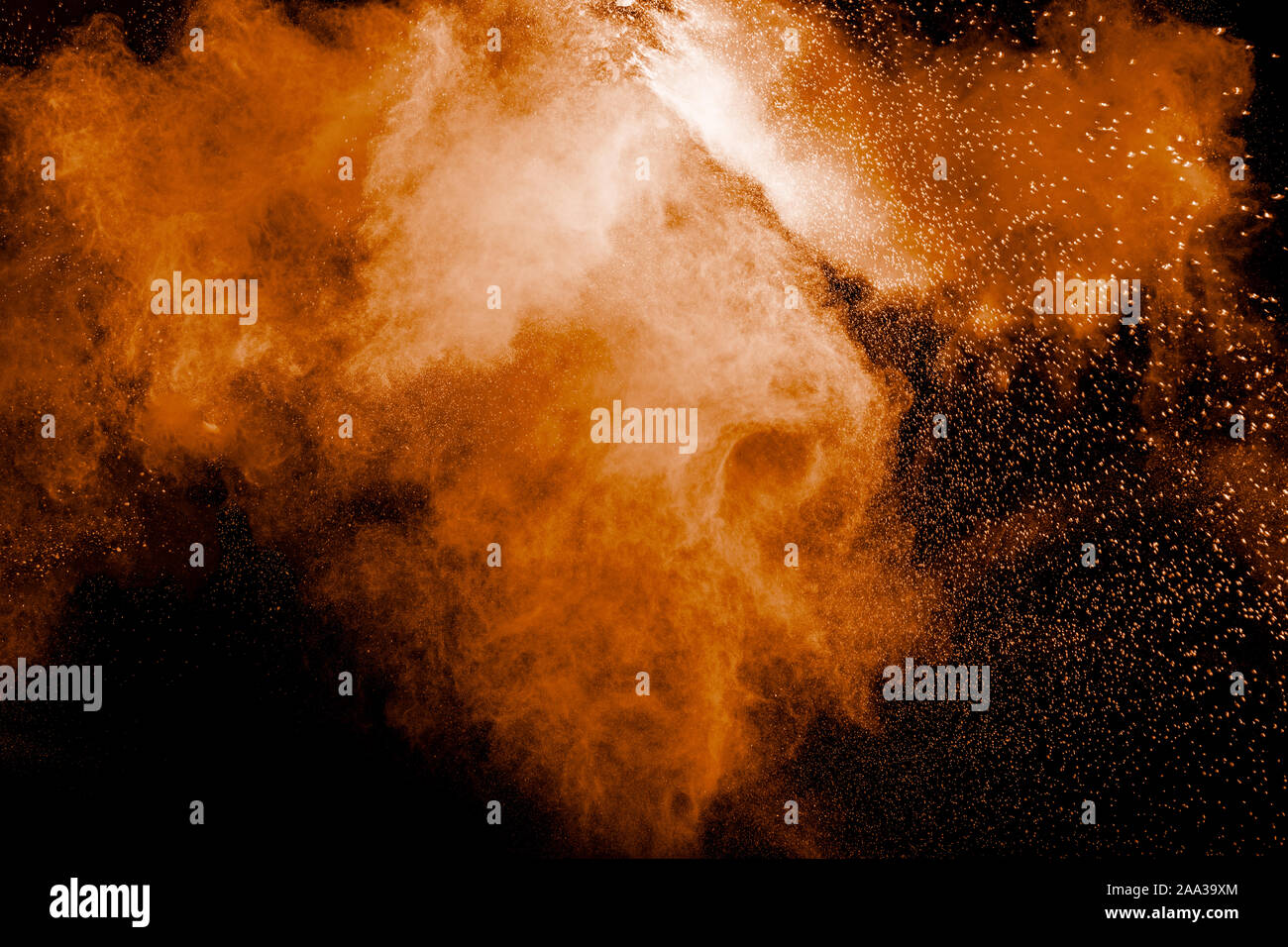 Orange color powder explosion on black background Stock Photo - Alamy