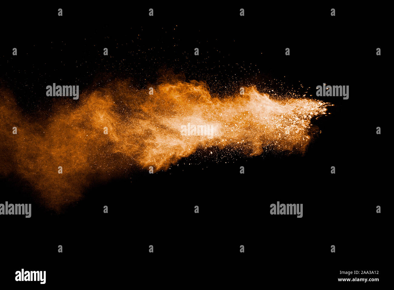 Orange color powder explosion on black background Stock Photo - Alamy