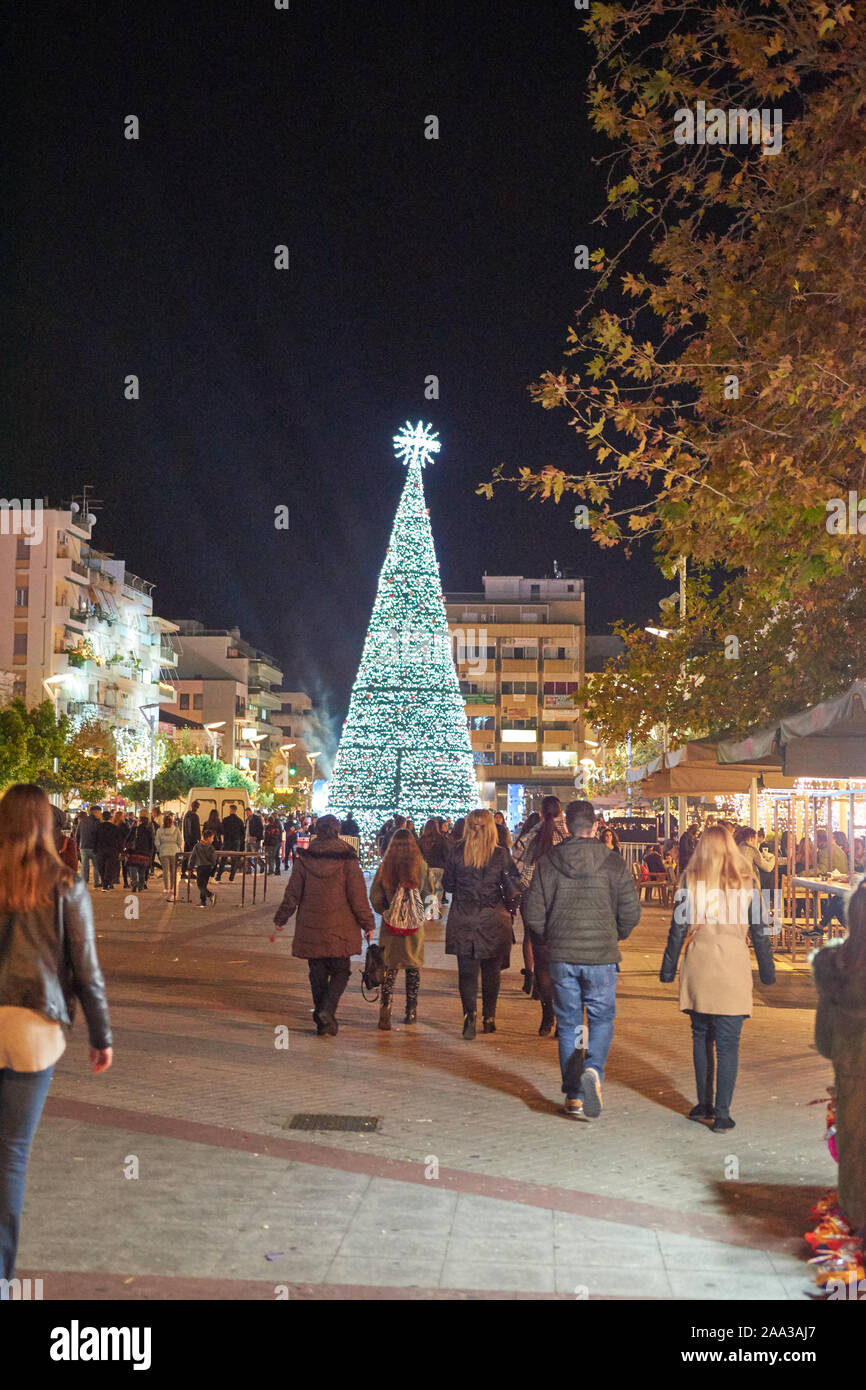 Christmas atmosphere in Kalamata, Greece with people walking by the ...