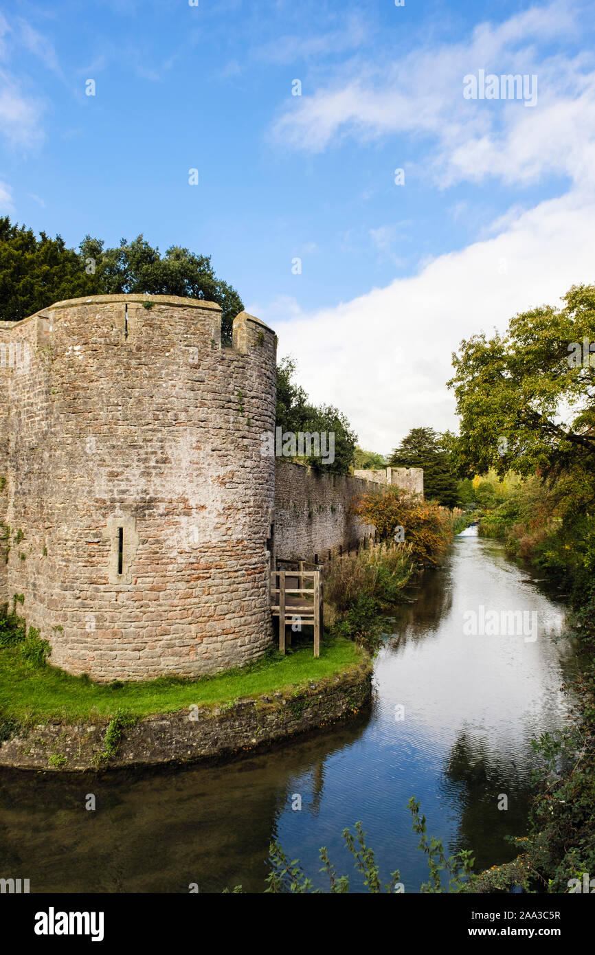 The 14th century walls and moat around the Bishop's Palace in autumn ...