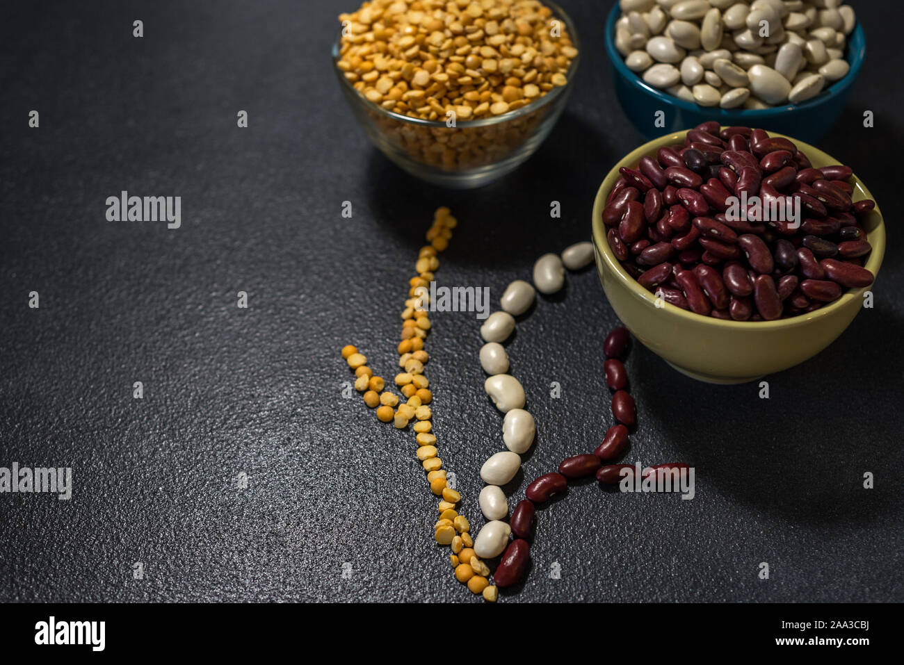 healthy eating vegetarian beans lentils and peas on a dark background ...