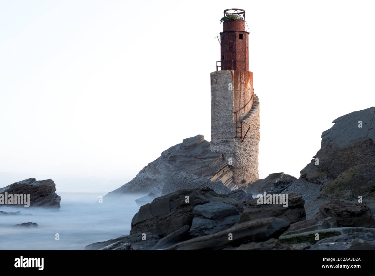 Derelict rusty simple lighthouse on cliffs on seaside in Gisborne in ...