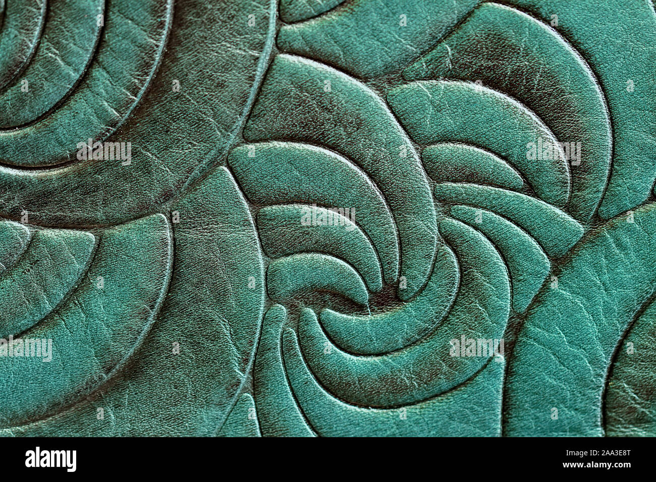 Texture of green mint genuine leather close-up, with embossed twirl ...