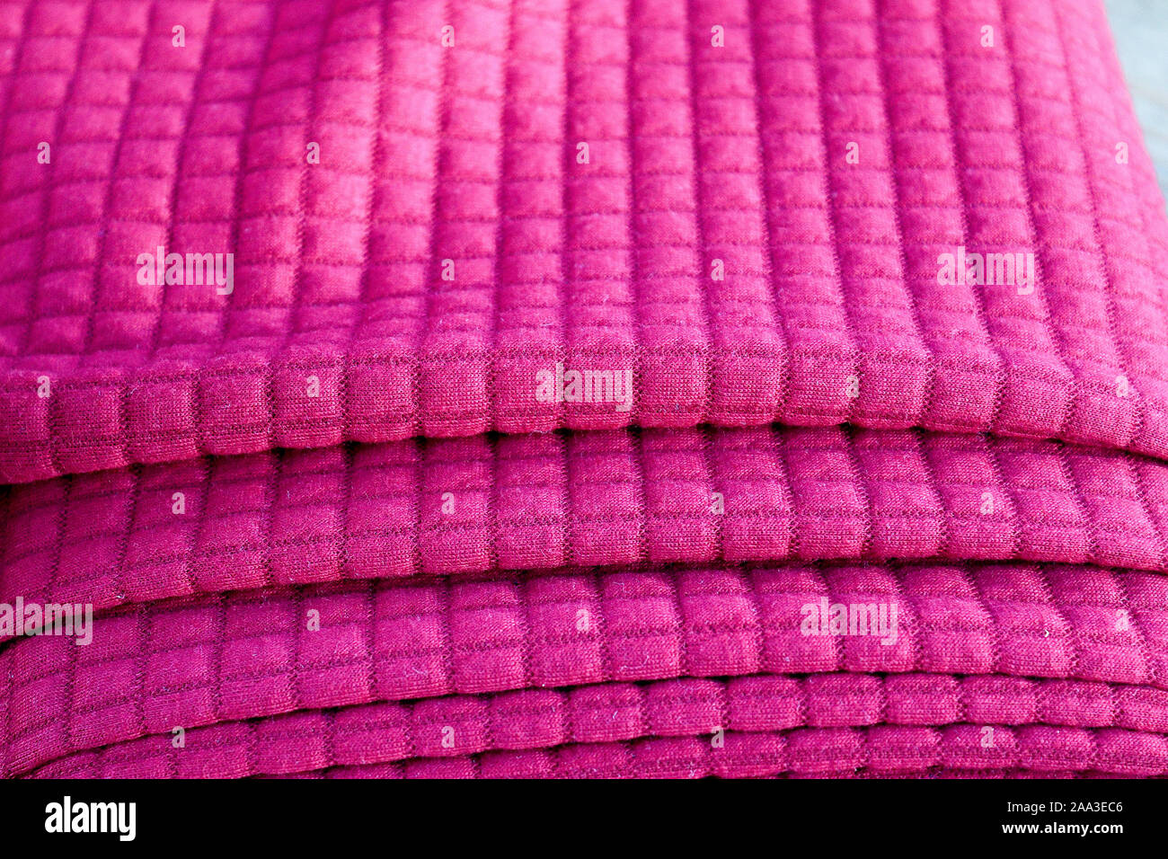 Close up view on folded cloth and fabric textures in different colors ...