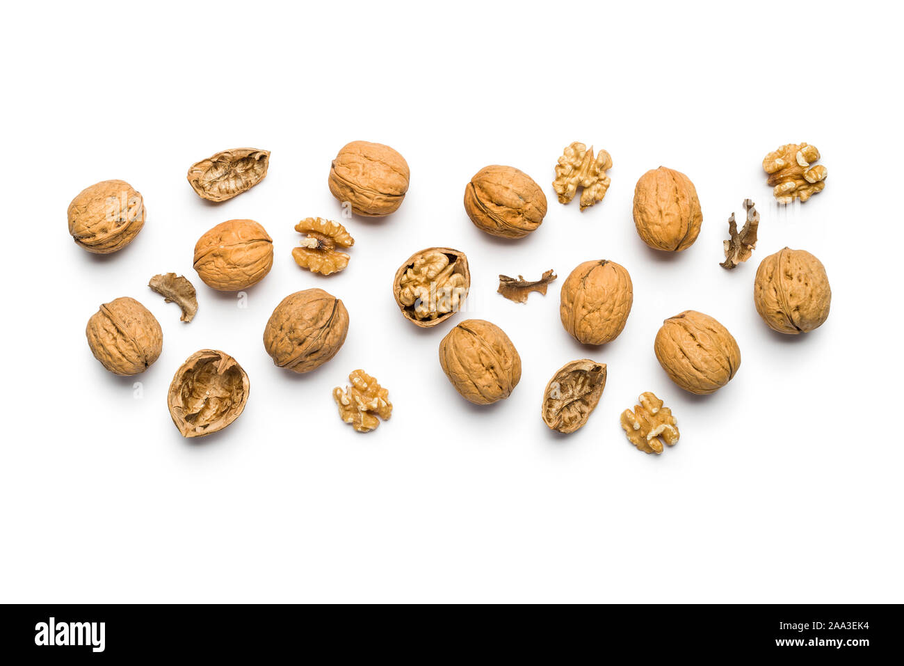 top view walnuts closed and broken scattered on a white background ...
