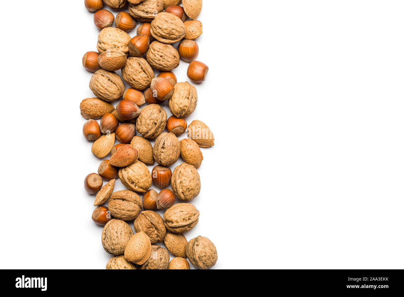 top view of mix of nuts scattered on white background with copy space ...