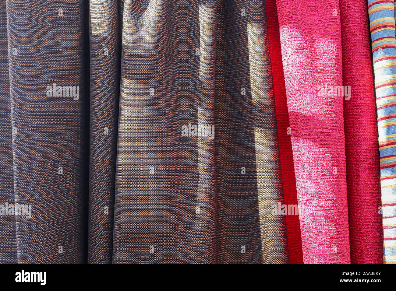 Close up view on folded cloth and fabric textures in different colors ...