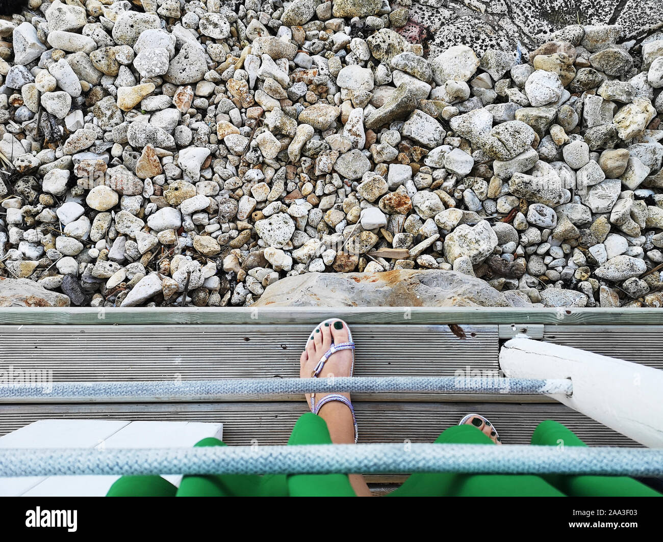 Overhead view of a woman's foot standing on a pier, Italy Stock Photo ...