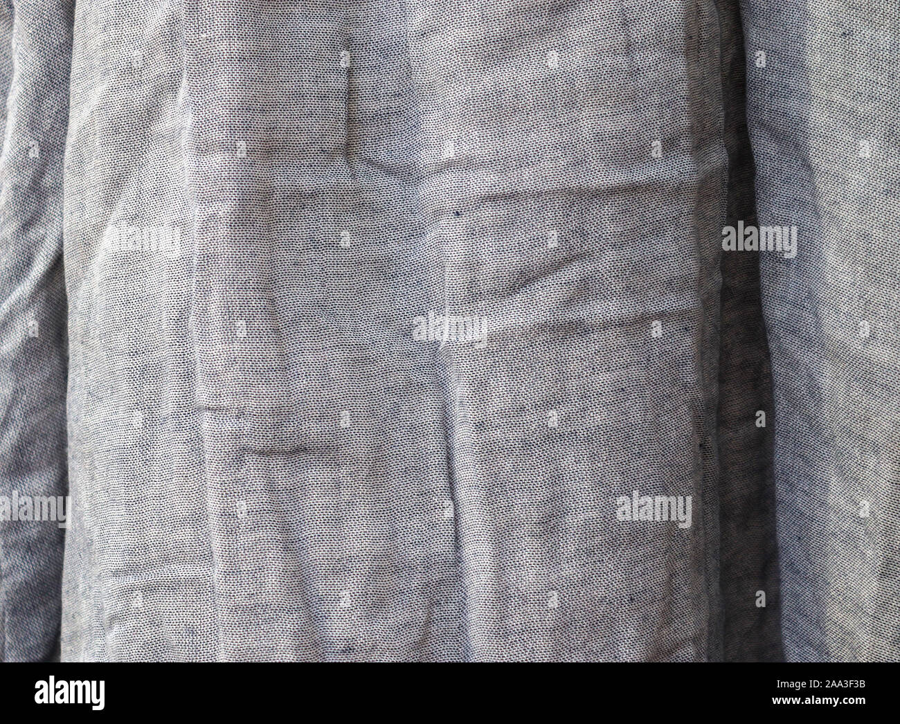Close up view on folded cloth and fabric textures in different colors ...