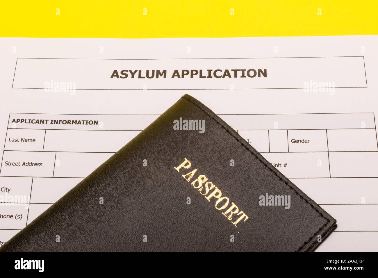 Travel concept showing a passport and an application form for asylum on ...