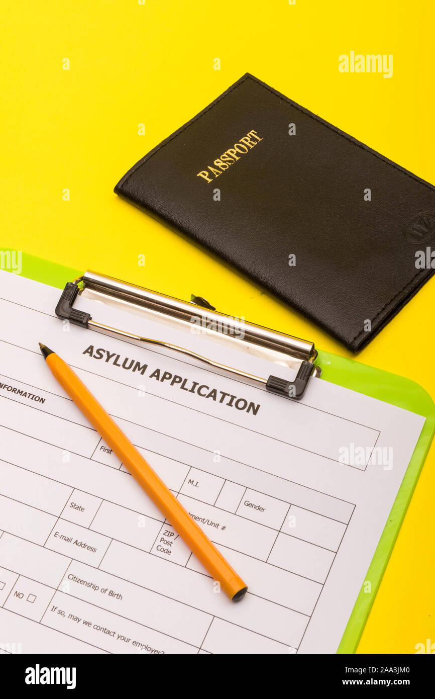Asylum concept showing an application form for asylum on a yellow ...