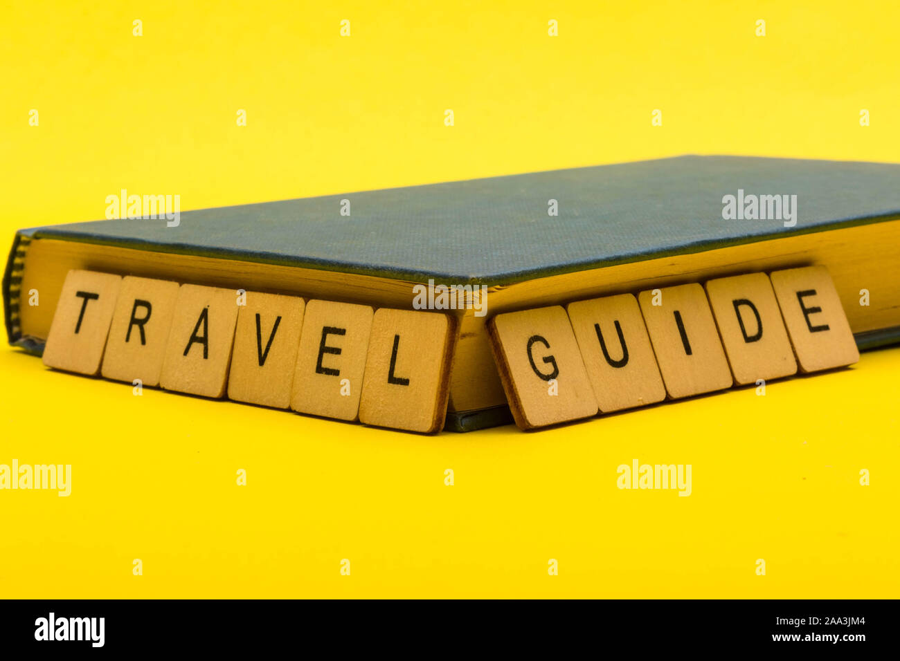 Travel concept showing a book with a sign reading travel guide on a ...