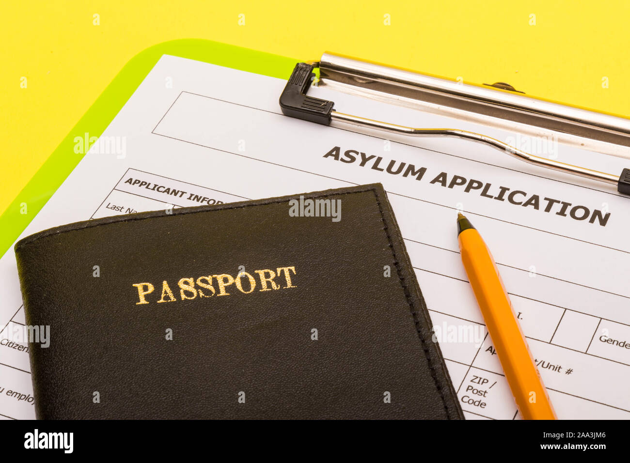Asylum concept showing an application form for asylum on a yellow ...
