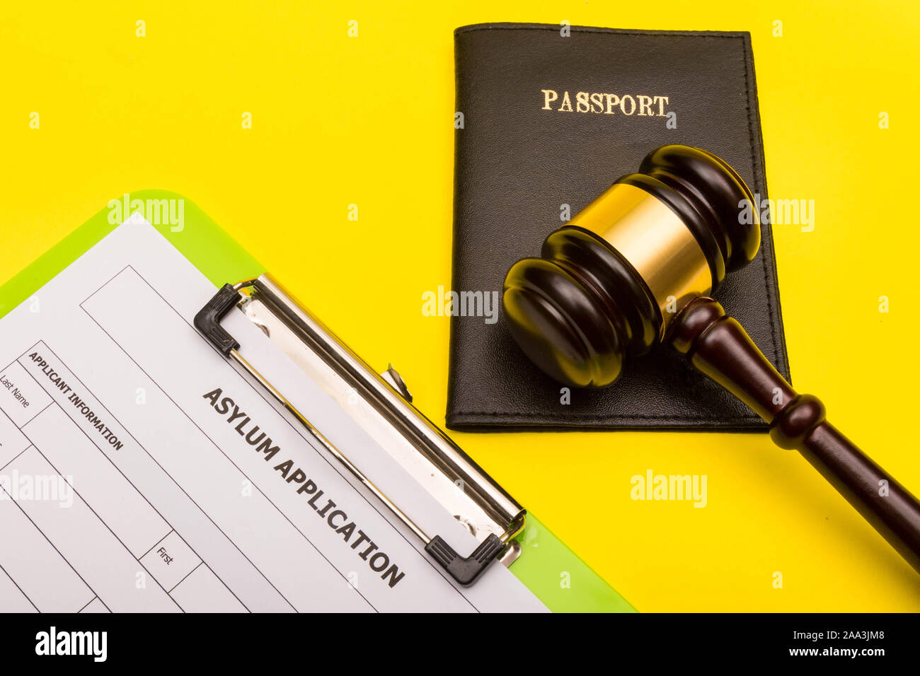 Asylum concept showing an application form for asylum on a yellow ...