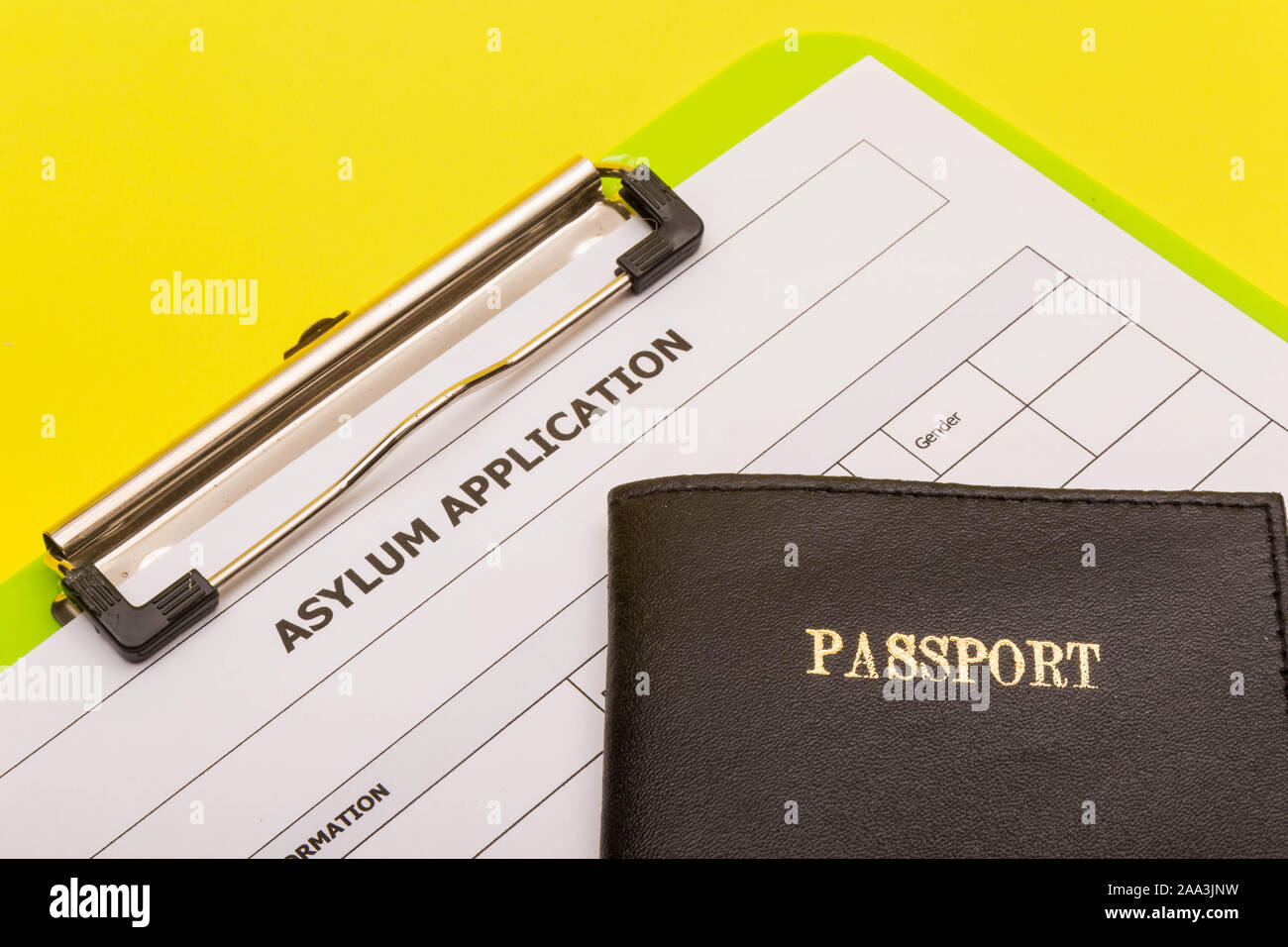 Asylum concept showing an application form for asylum on a yellow ...