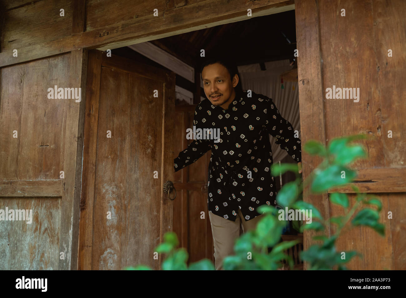 Asian man open the door traditional house Stock Photo - Alamy