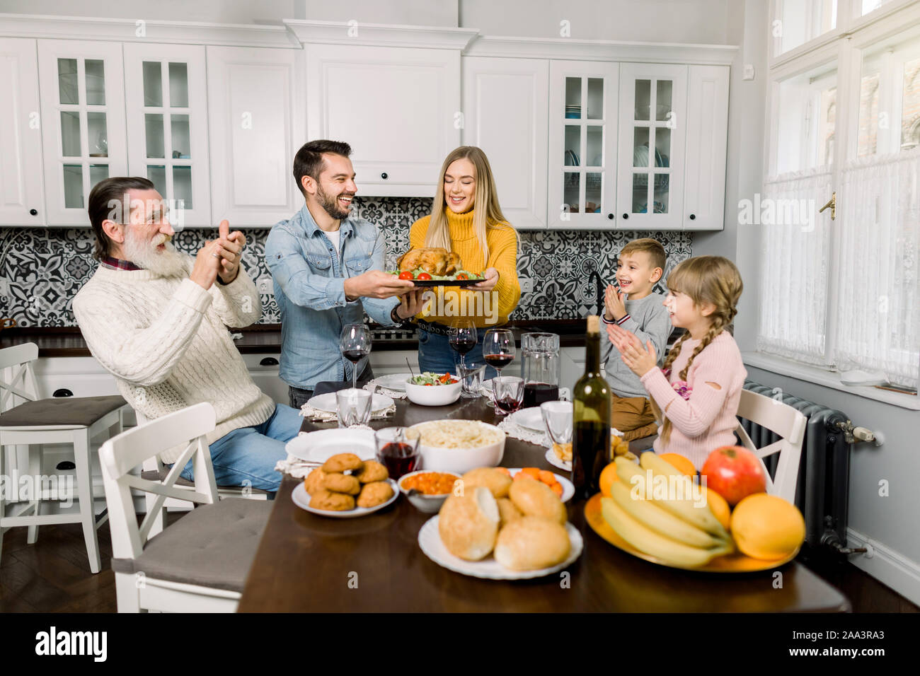 beautiful mother and handsome father carrying turkey for family on ...