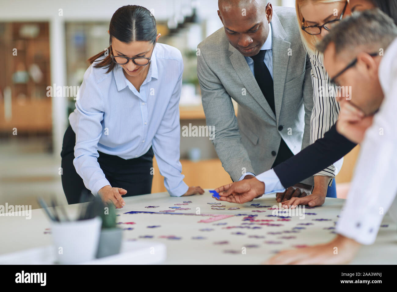 Colleagues solve puzzle hi-res stock photography and images - Alamy