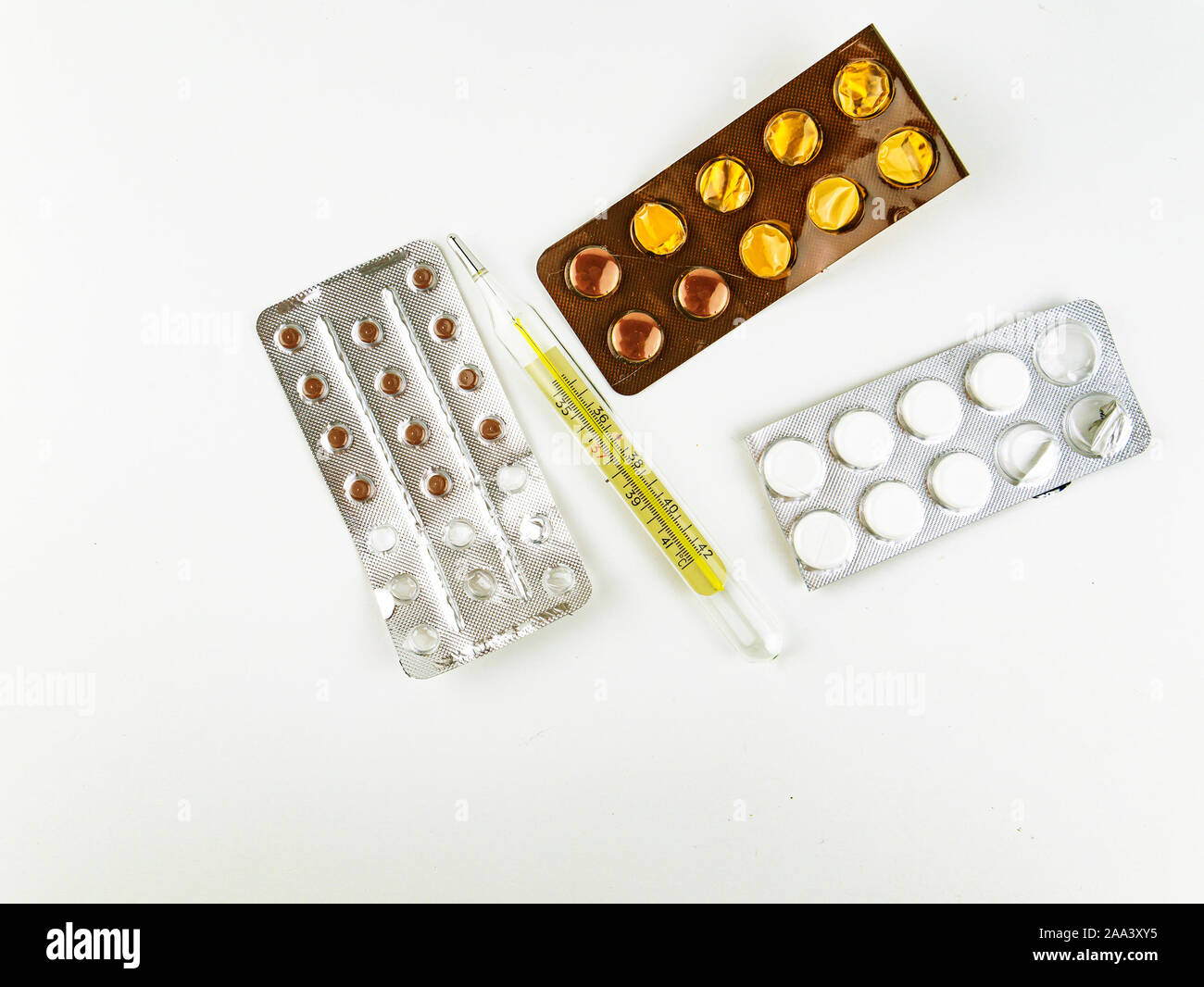 Mercury medical thermometer and pills on a white background. Place for ...