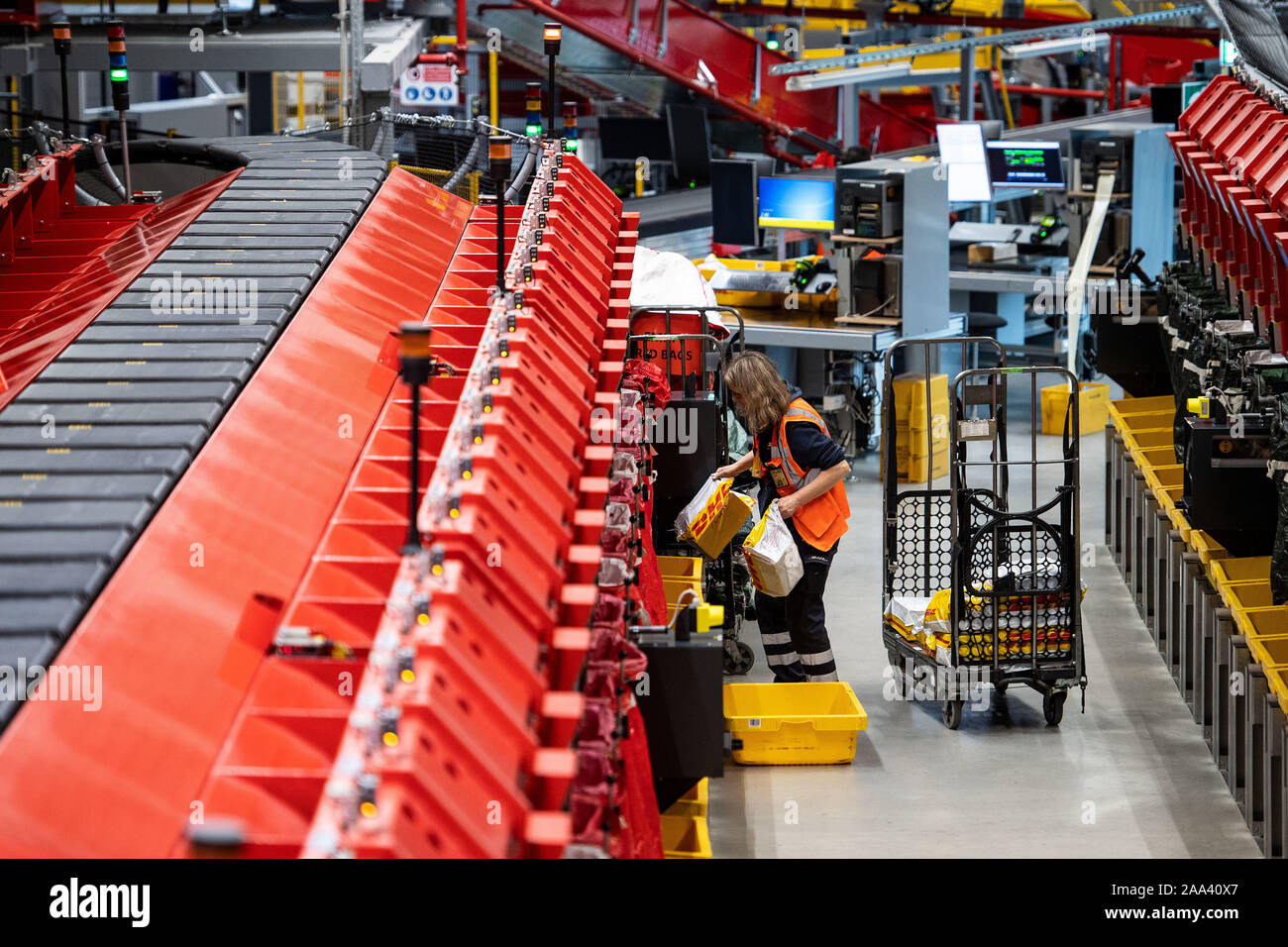 Cologne, Germany. 19th Nov, 2019. A DHL employee works at the company's ...