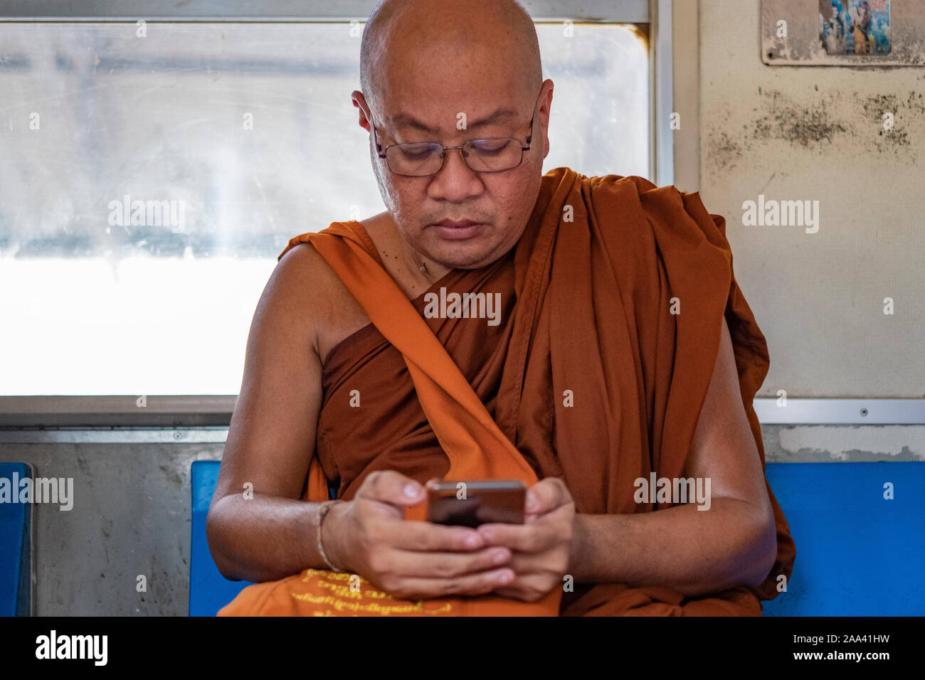 Buddhist monk and mobile hi-res stock photography and images - Alamy