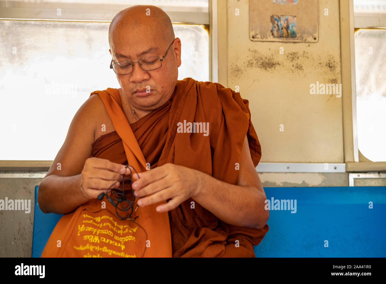 Old monk in orange robe hi-res stock photography and images - Alamy